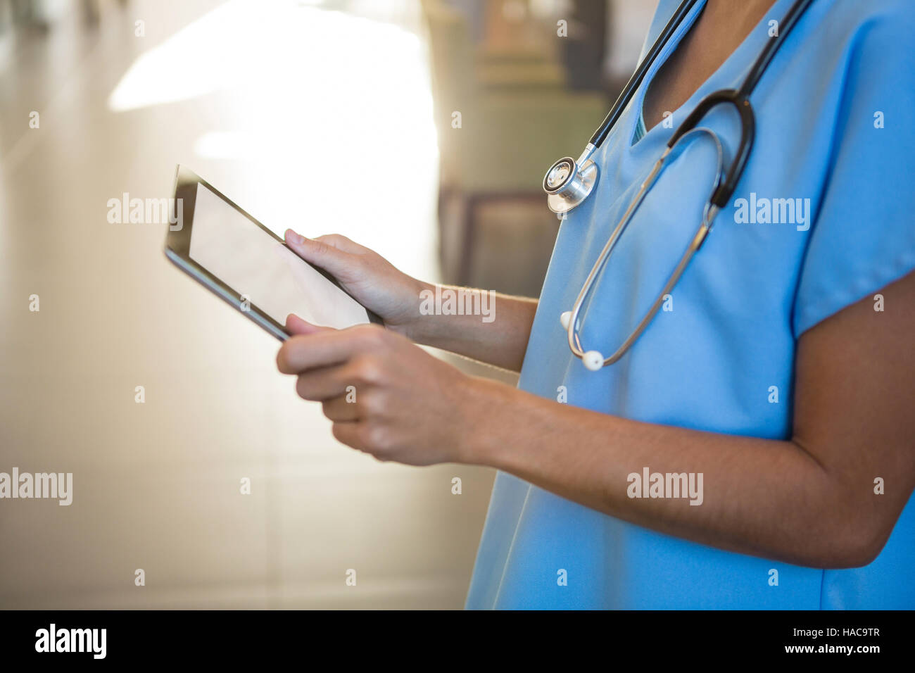 Doctor using digital tablet in hospital Stock Photo - Alamy