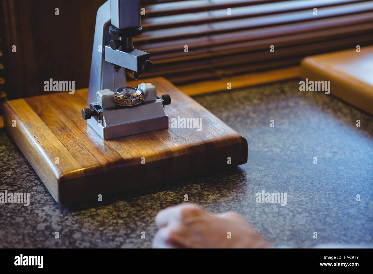 Watch placed on microscope for repair Stock Photo - Alamy