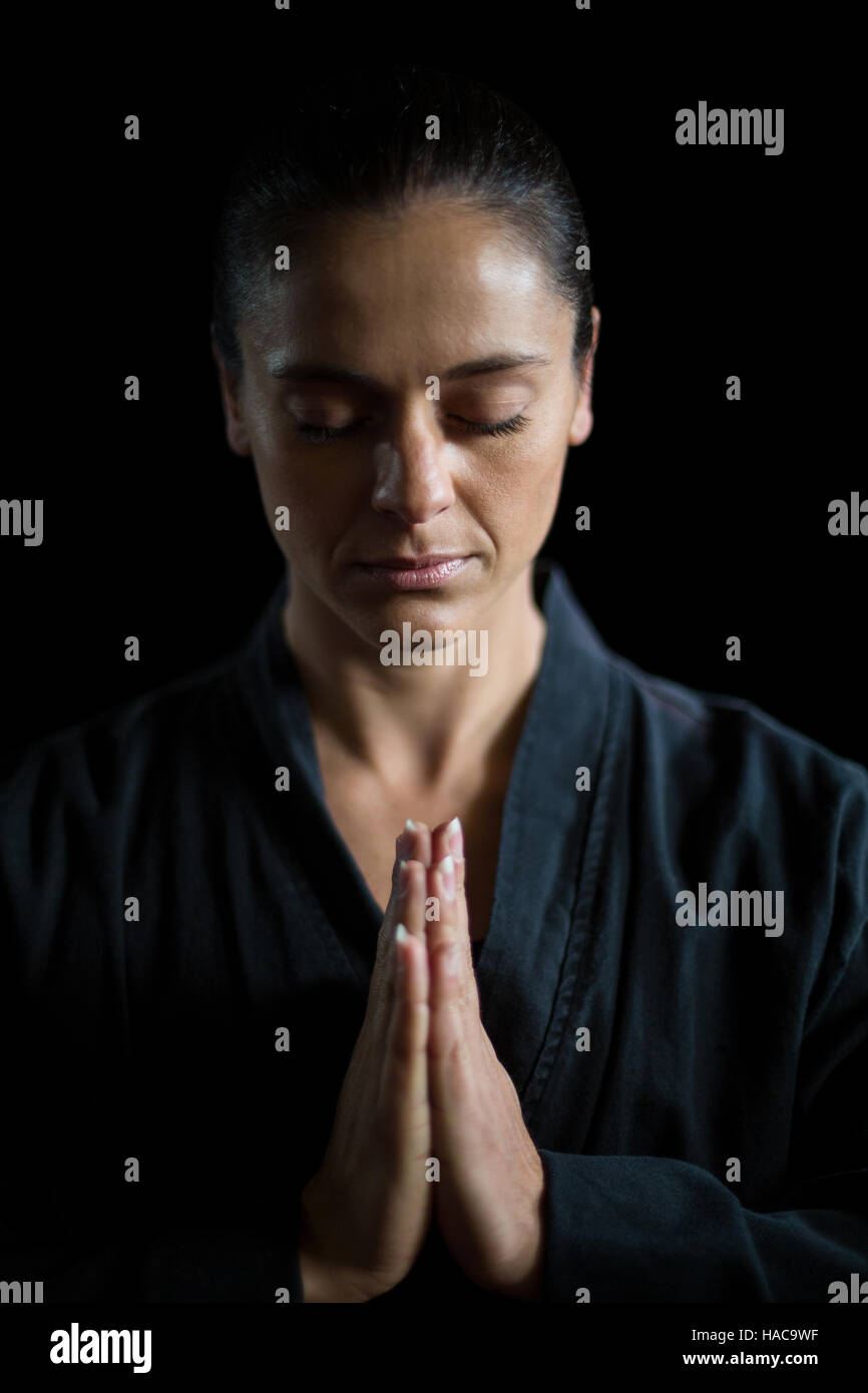 Female karate player in prayer pose Stock Photo - Alamy