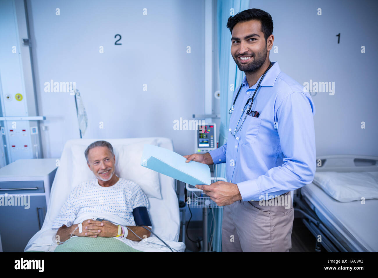 Doctor checking medical report of patient Stock Photo - Alamy