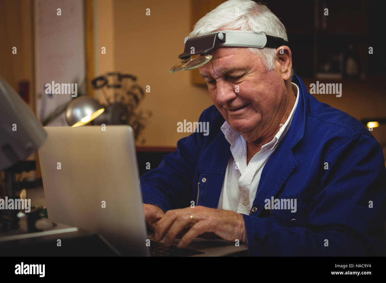 Horologist working on laptop Stock Photo - Alamy