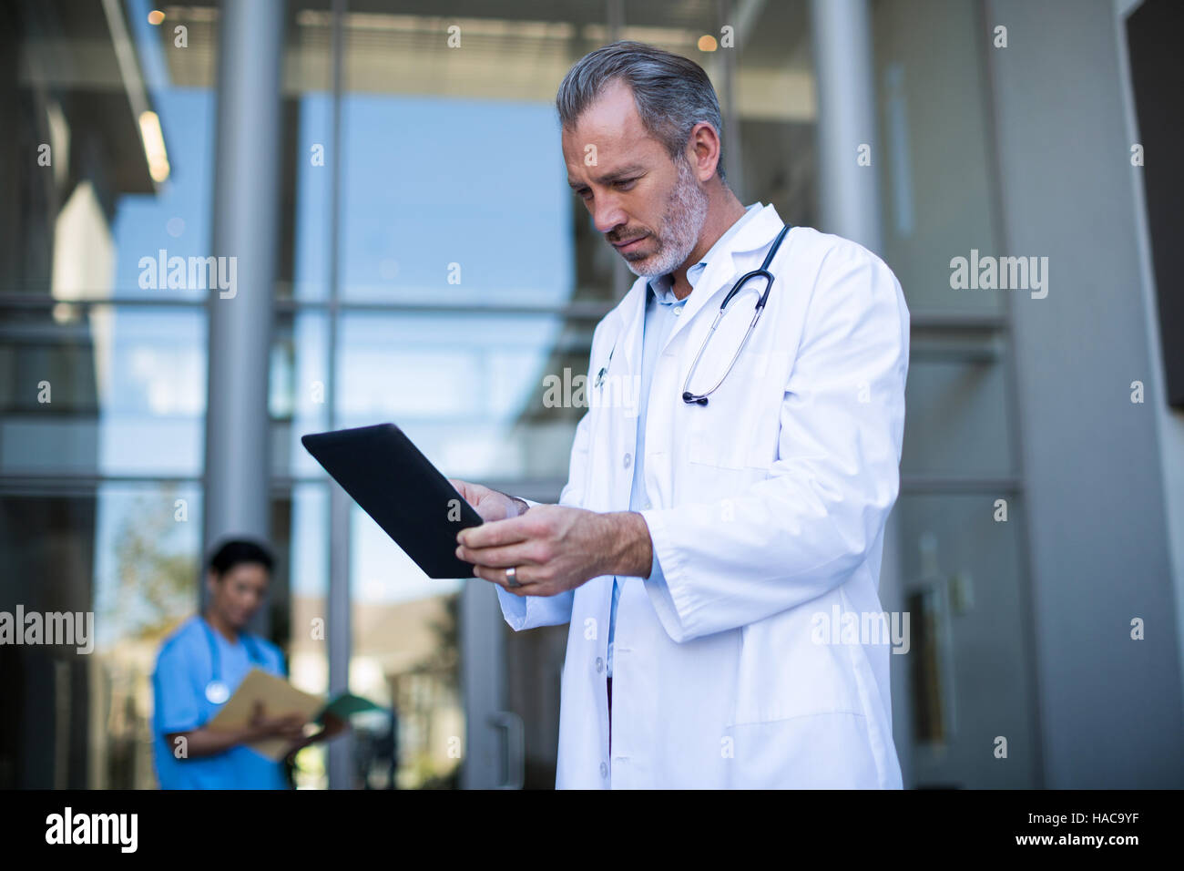 Doctor using digital tablet Stock Photo - Alamy