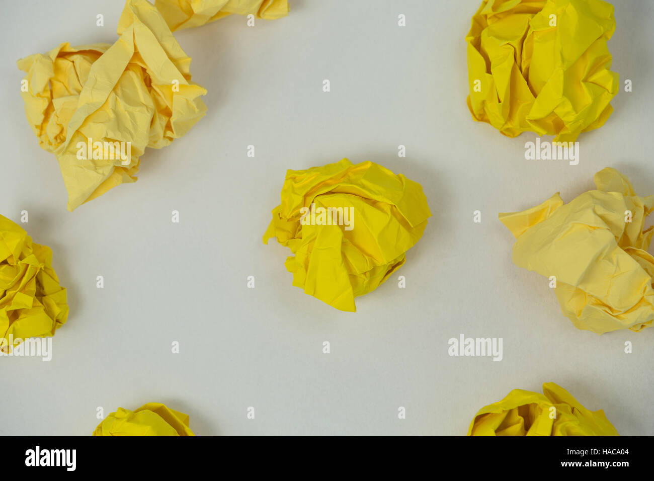 Yellow crumpled paper balls on a white background Stock Photo - Alamy