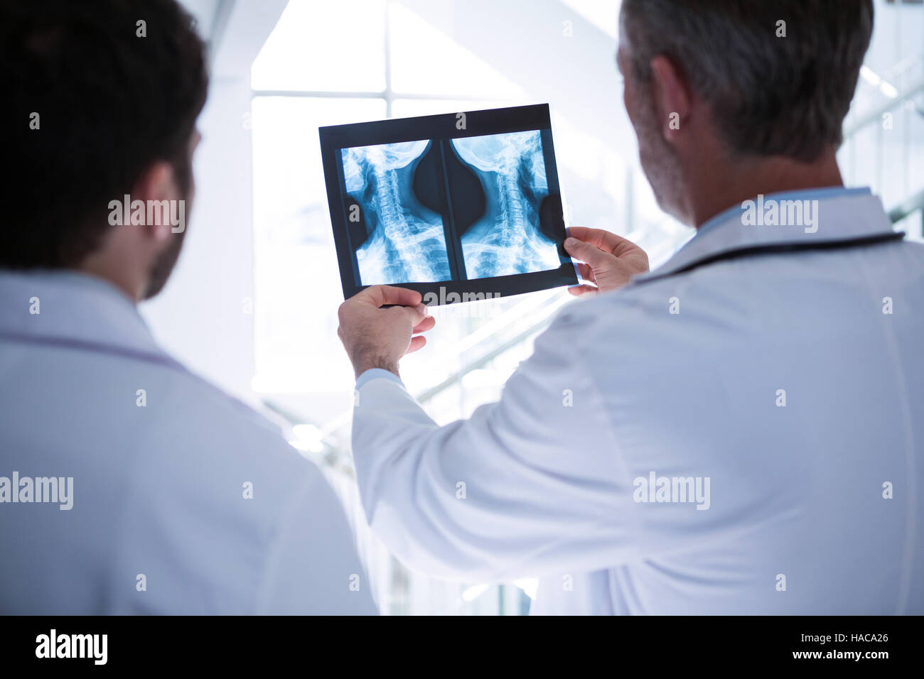 Doctors having discussion on x-ray report in corridor Stock Photo - Alamy