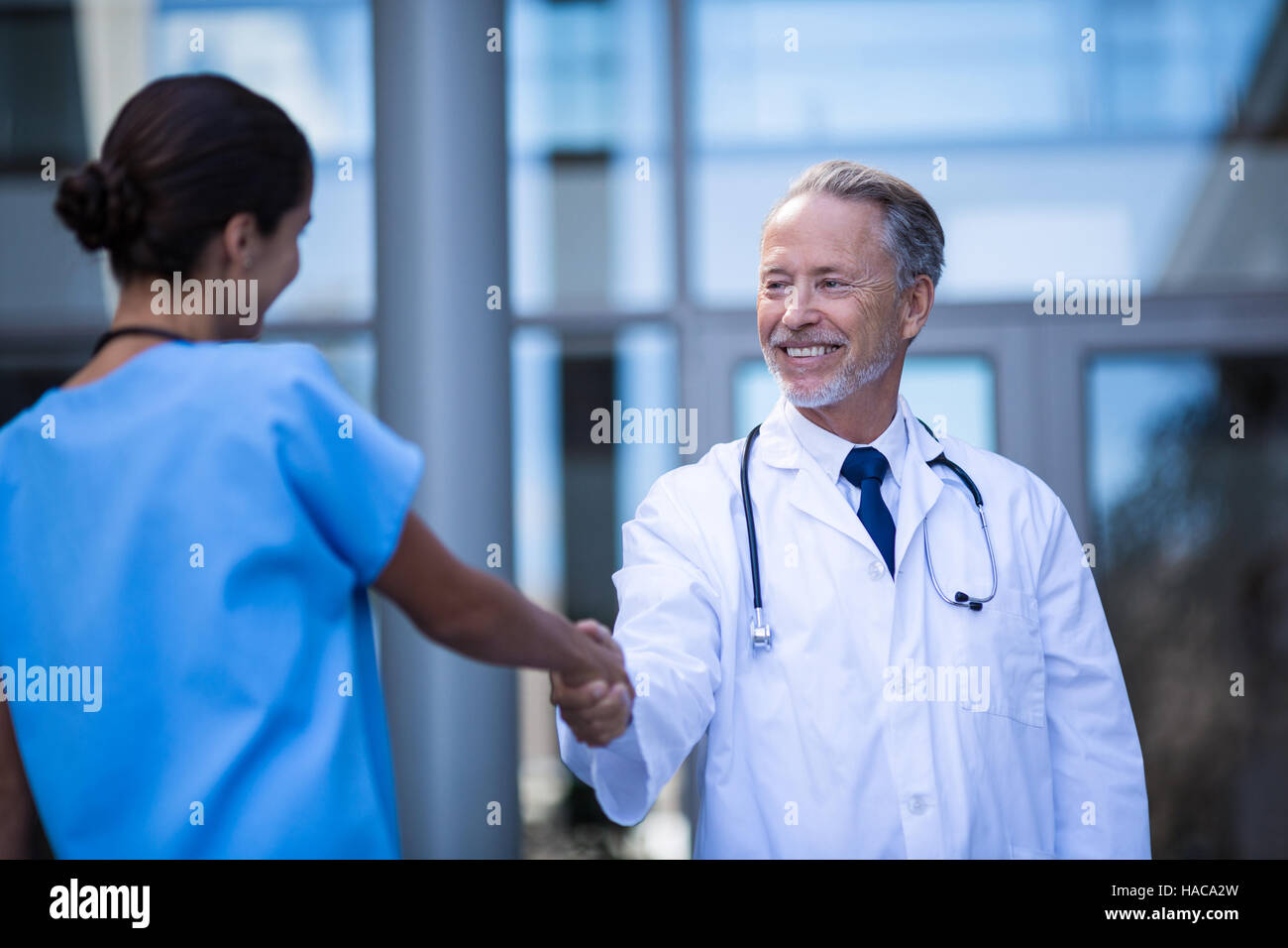 Happy doctor handshake nurse hi-res stock photography and images - Alamy