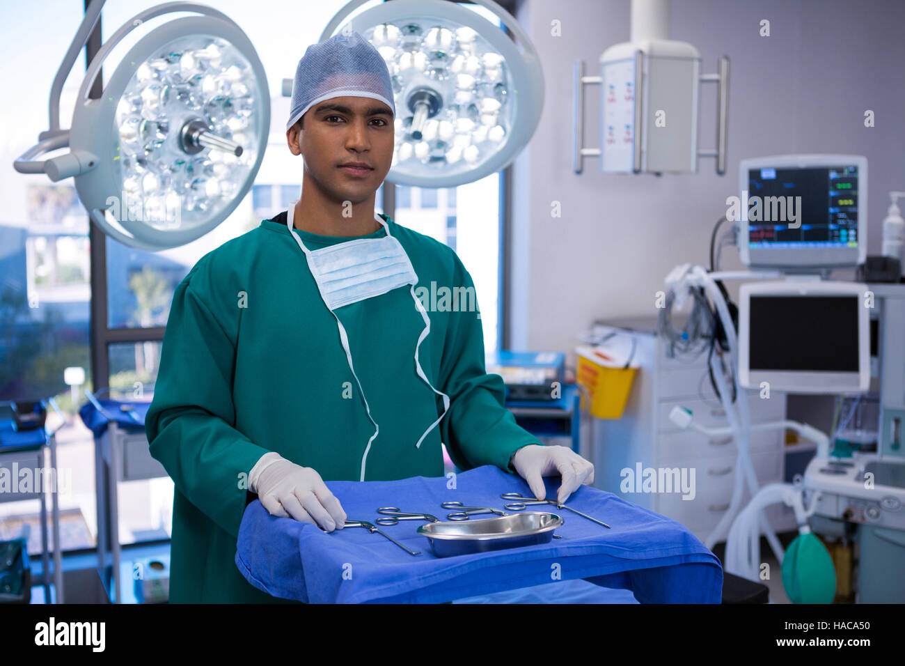 Portrait of surgeon standing in operation room Stock Photo - Alamy
