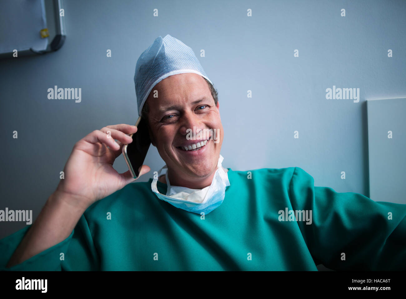 Smiling surgeon talking on mobile phone Stock Photo - Alamy