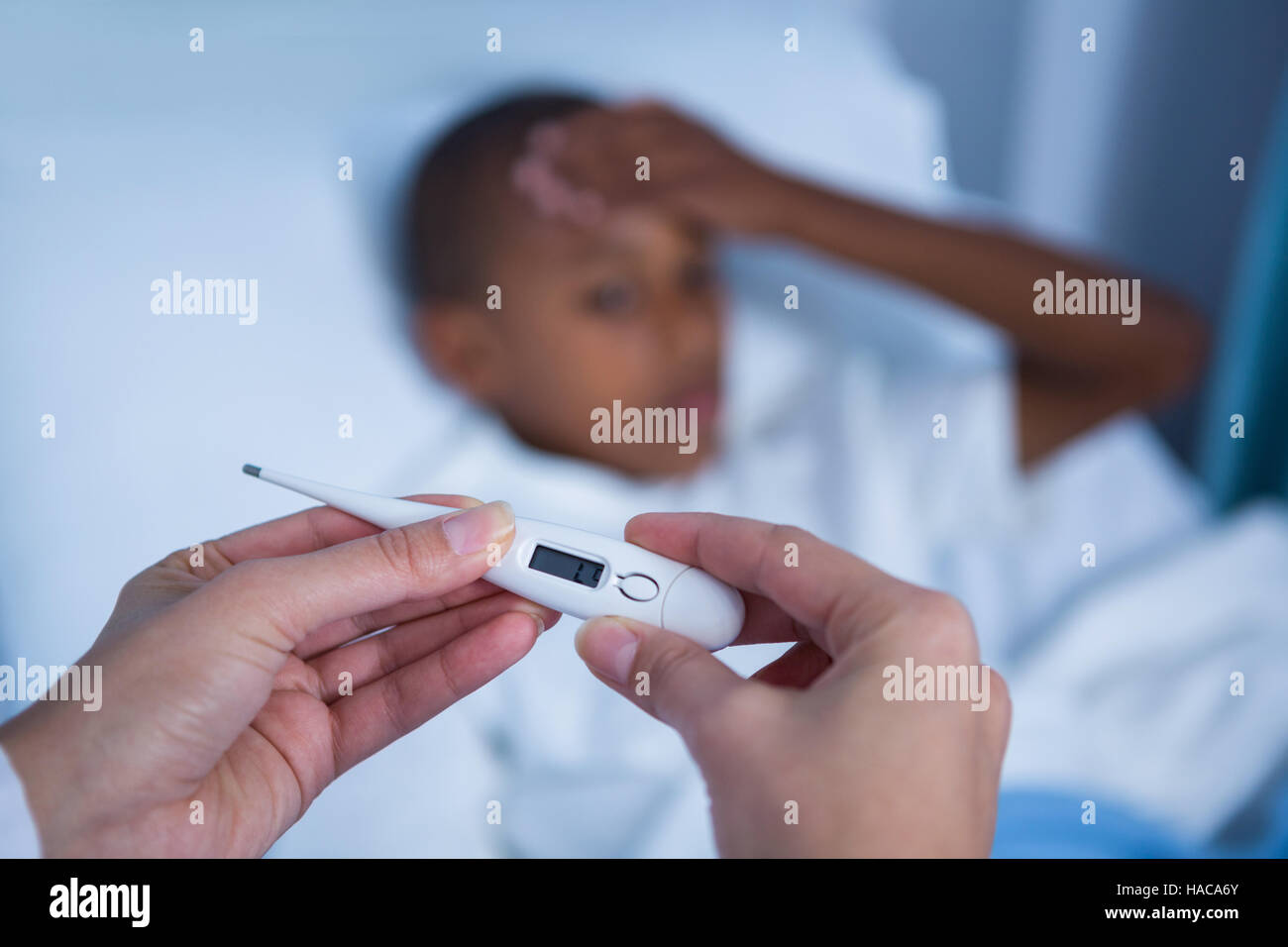 Doctor checking patient temperature in hi-res stock photography and ...