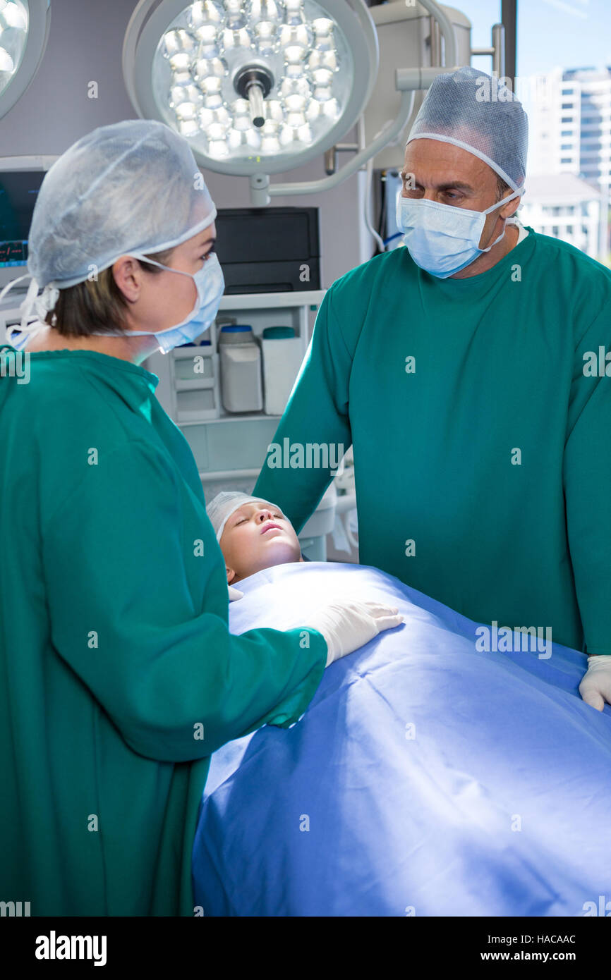 Surgeons interacting while operating patient Stock Photo - Alamy
