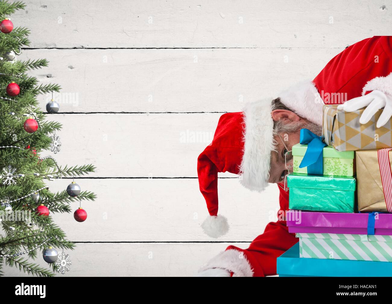 Santa behind the tree hi-res stock photography and images - Alamy