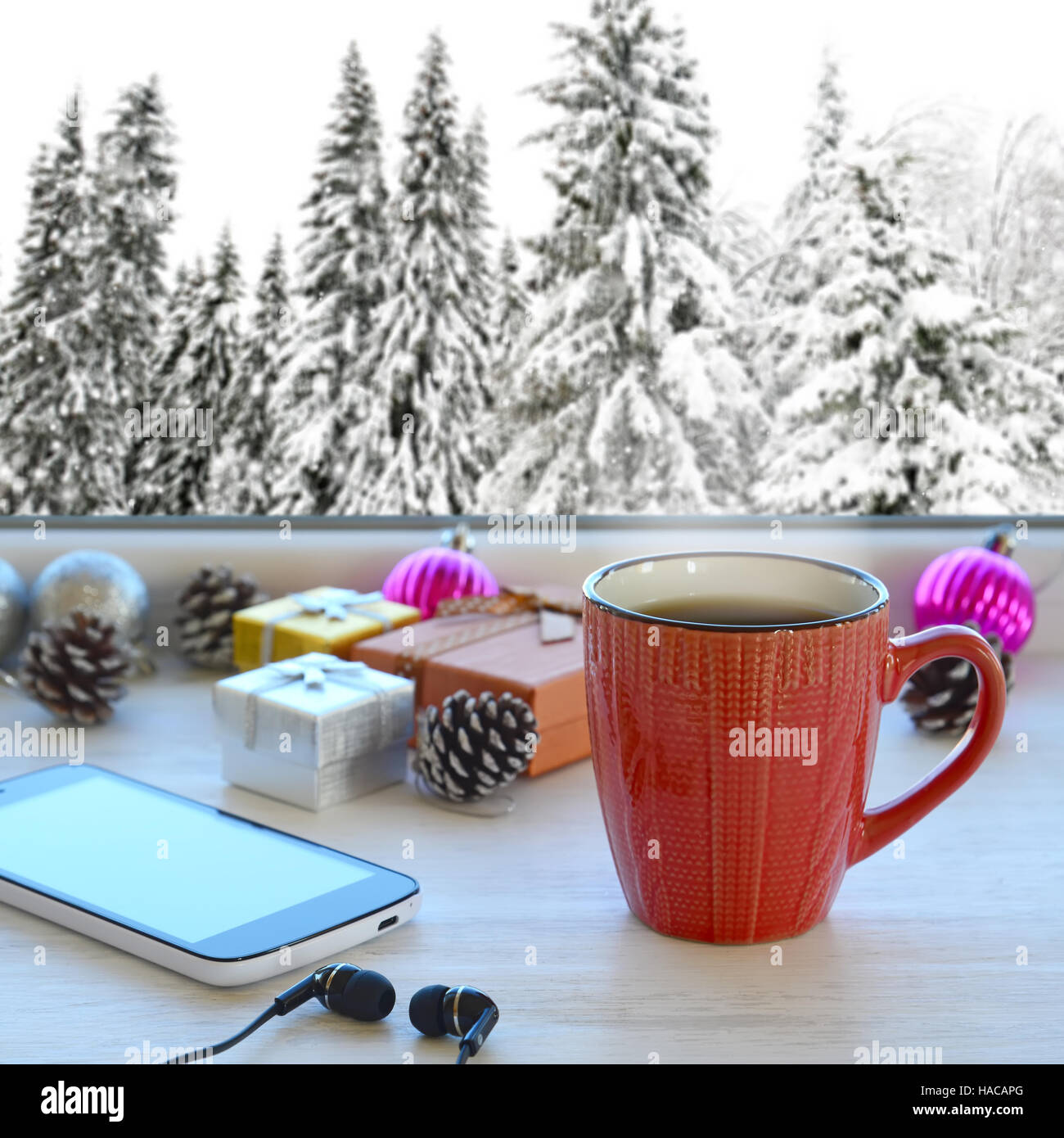 Coffee cup on a window sill. In the background, a beautiful winter ...