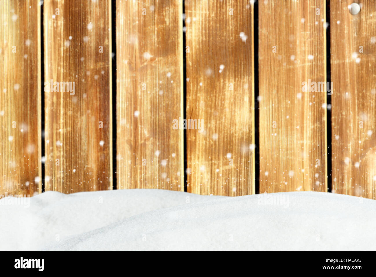 Winter background with snowfall on the old wooden barn wall and ...