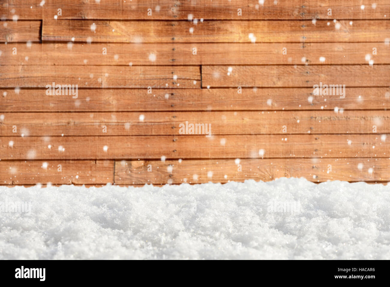 Winter background with snowfall on the old wooden barn wall and ...