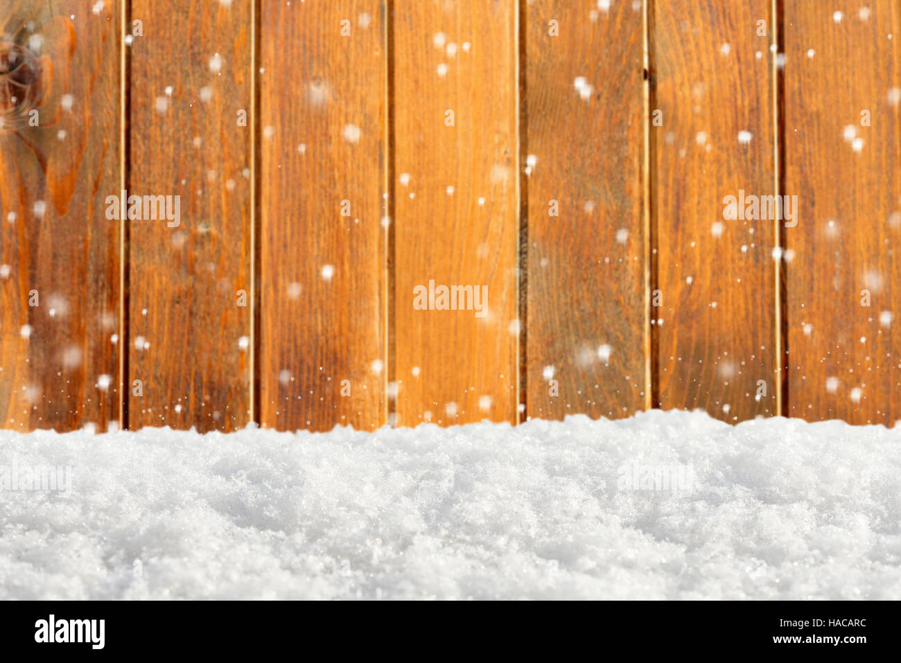Winter background with snowfall on the old wooden barn wall and ...