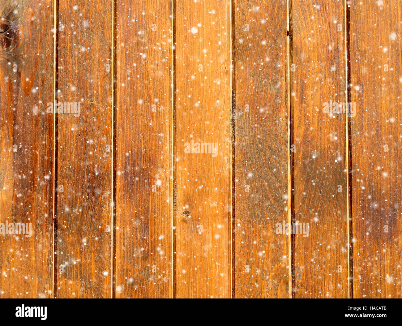 Winter background with snowfall on the old wooden barn wall and ...