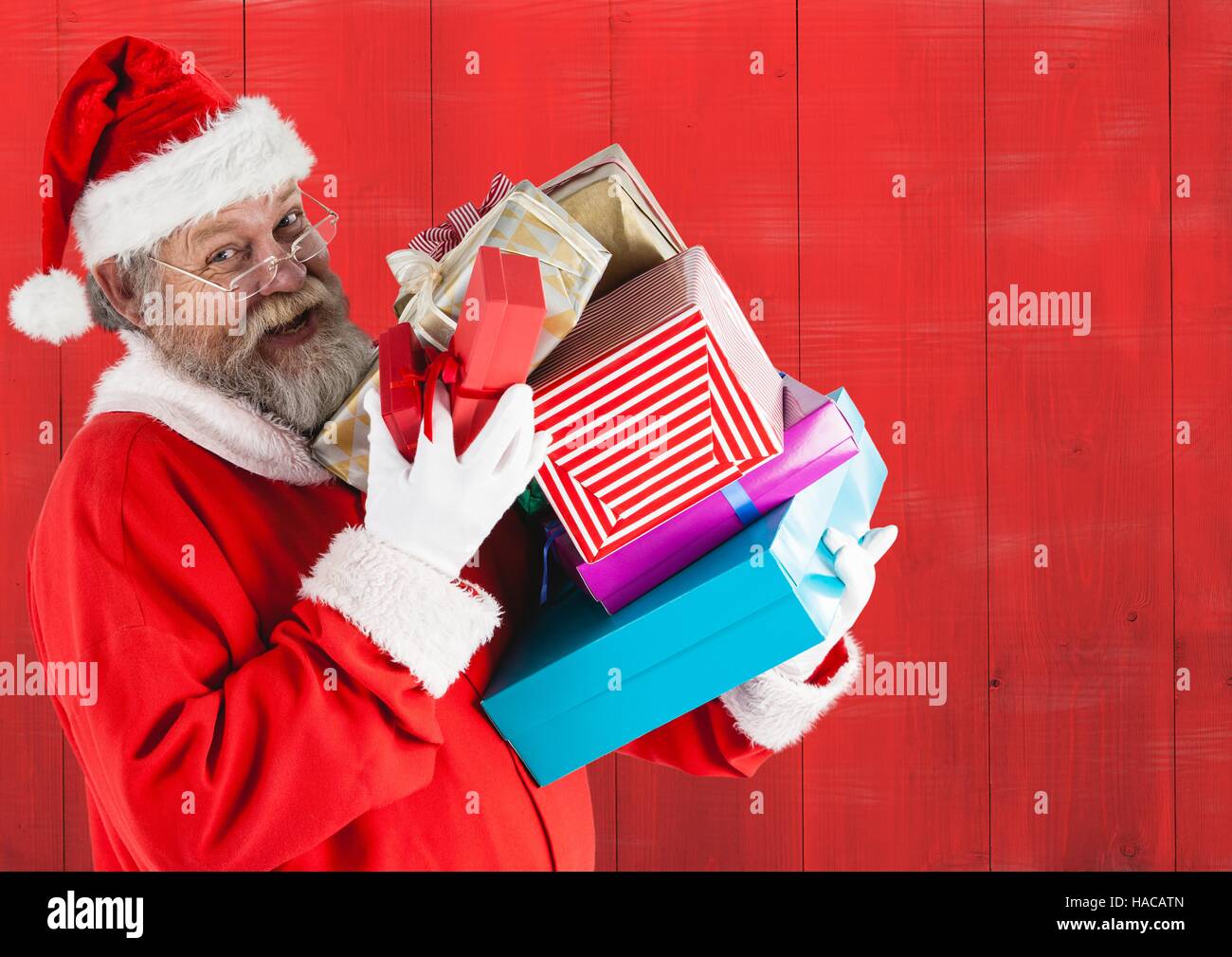 Santa claus holding gift boxes Stock Photo - Alamy
