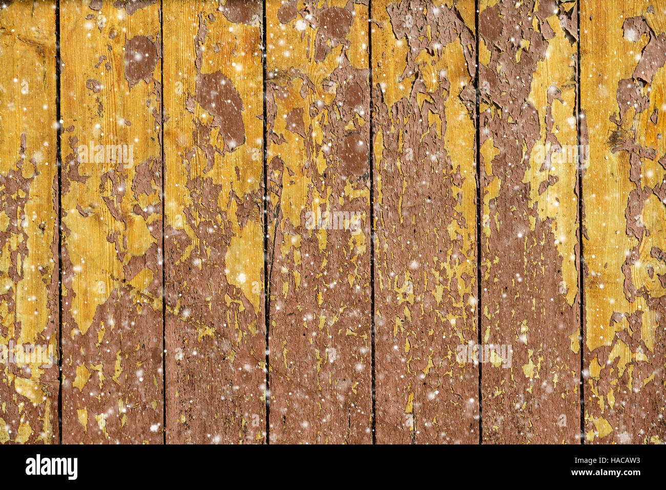 Winter background with snowfall on the old wooden barn wall and ...
