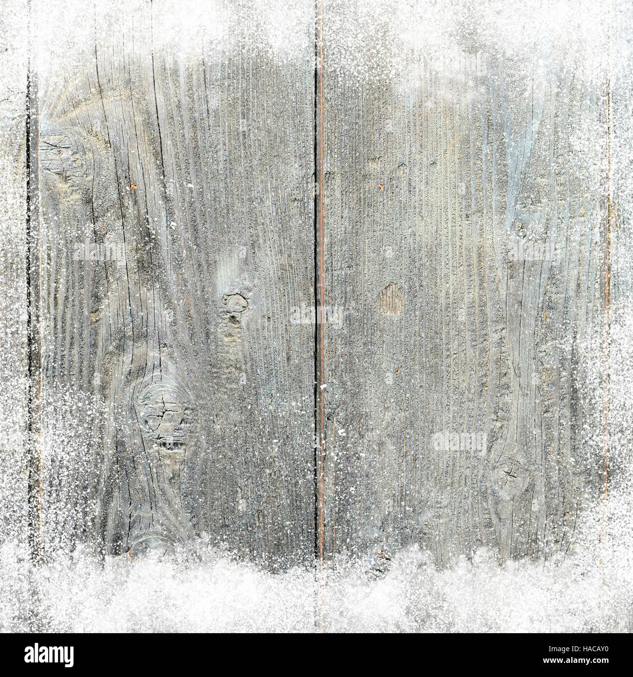 Winter background with snowfall on the old wooden barn wall and ...