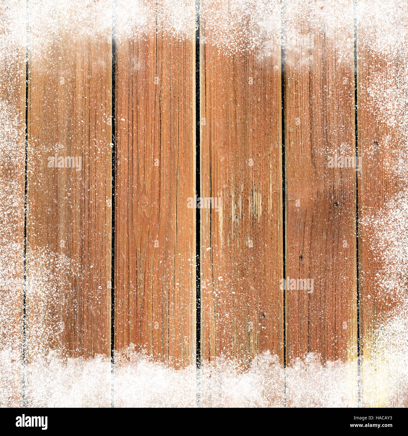 Winter background with snowfall on the old wooden barn wall and ...