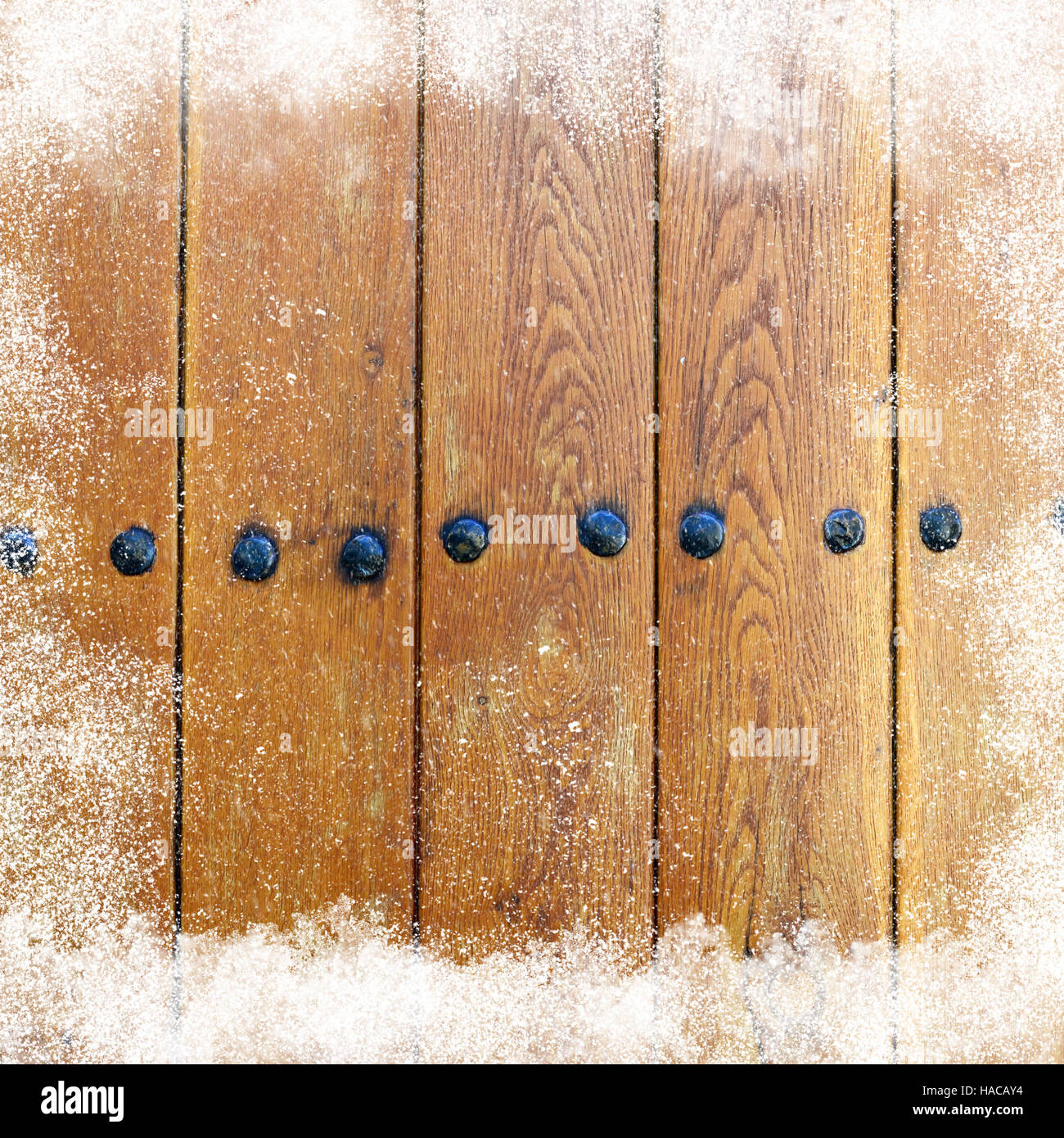 Winter background with snowfall on the old wooden barn wall and ...