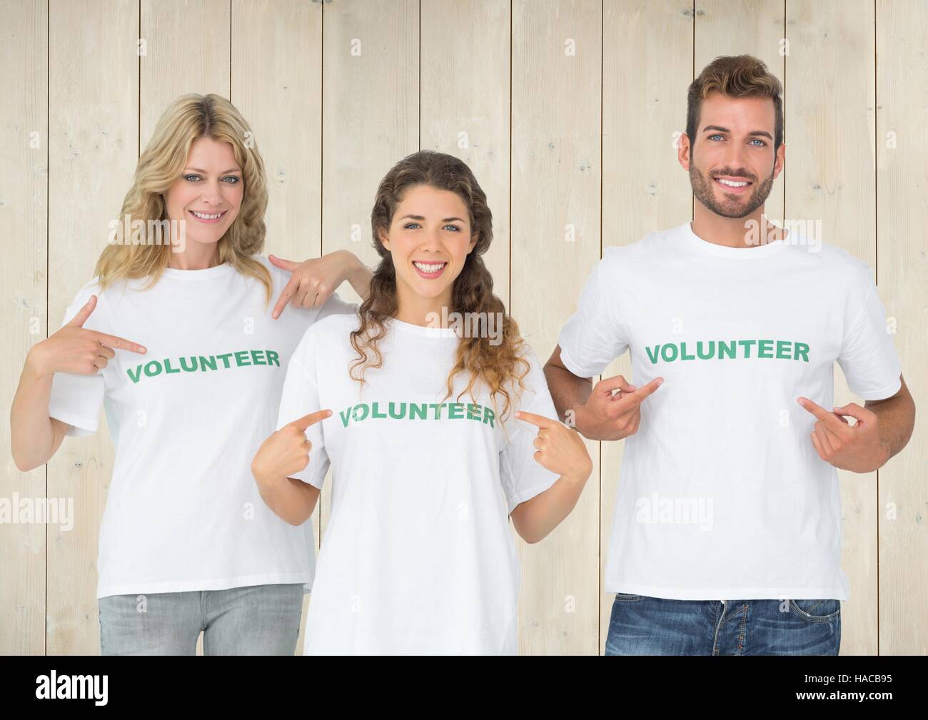 Three volunteer pointing at message printed on their tshirt Stock Photo ...
