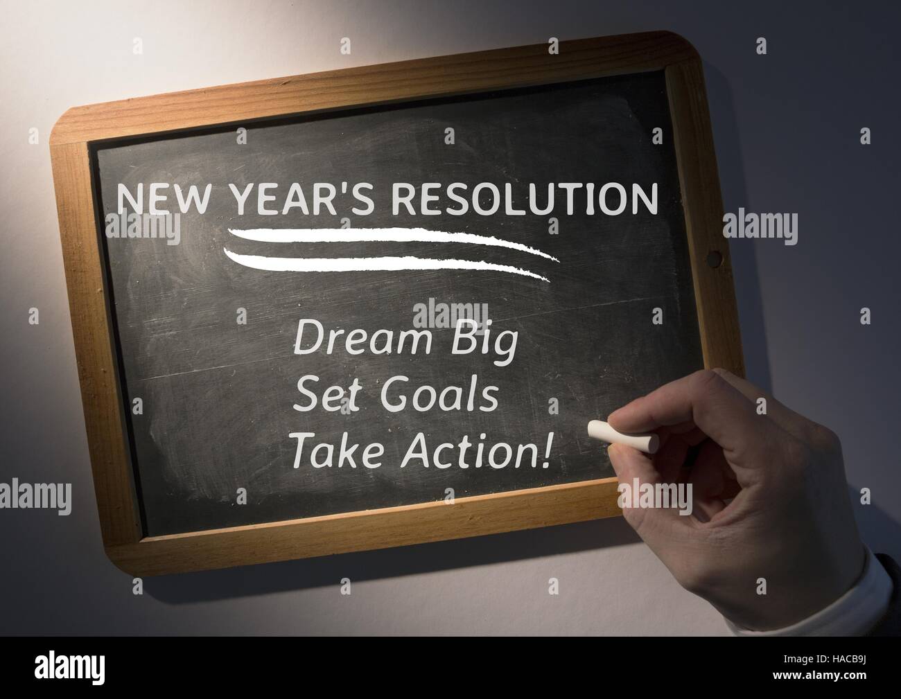 Hand writing new year resolution on slate Stock Photo - Alamy