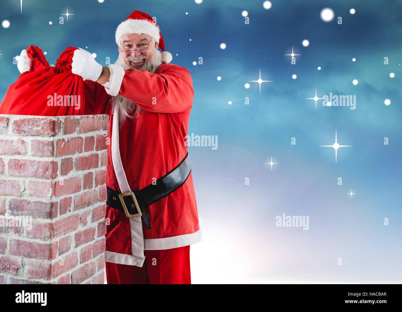 Smiling santa claus removing gift sack from chimney Stock Photo - Alamy