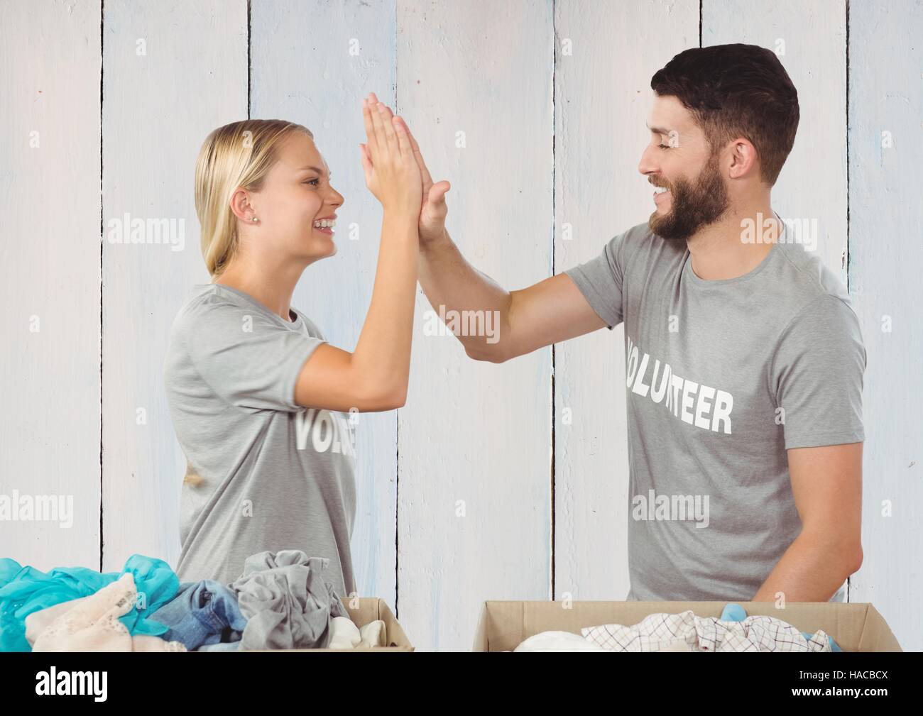 Volunteer couple giving high five to each other Stock Photo - Alamy