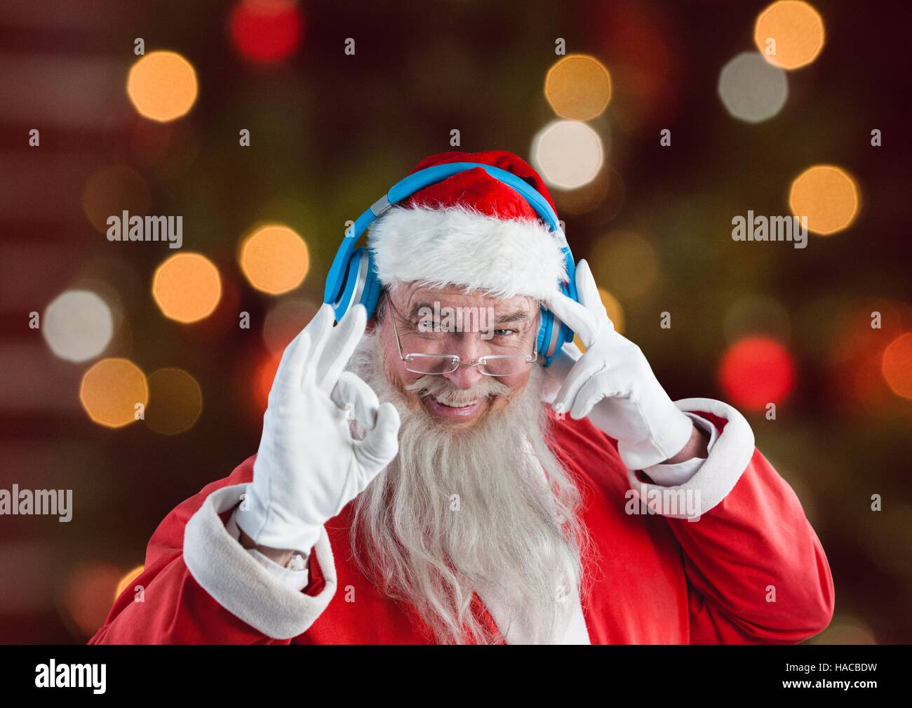 Cheerful Santa claus wearing headphones Stock Photo - Alamy