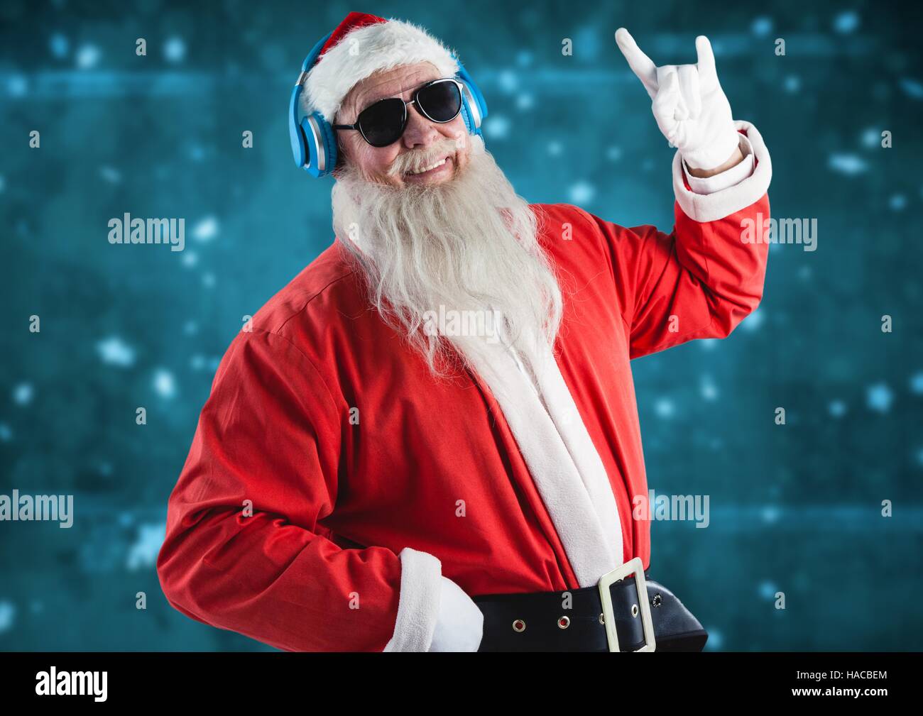 Santa gesturing while listening music on headphones Stock Photo - Alamy
