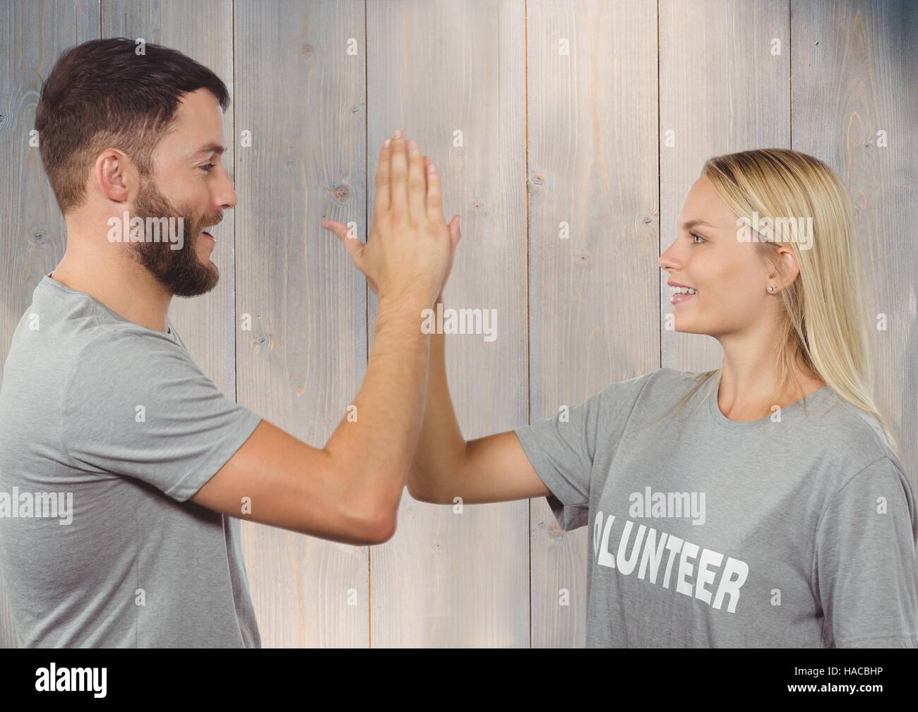 Volunteer couple in tshirt giving high five to each other Stock Photo ...