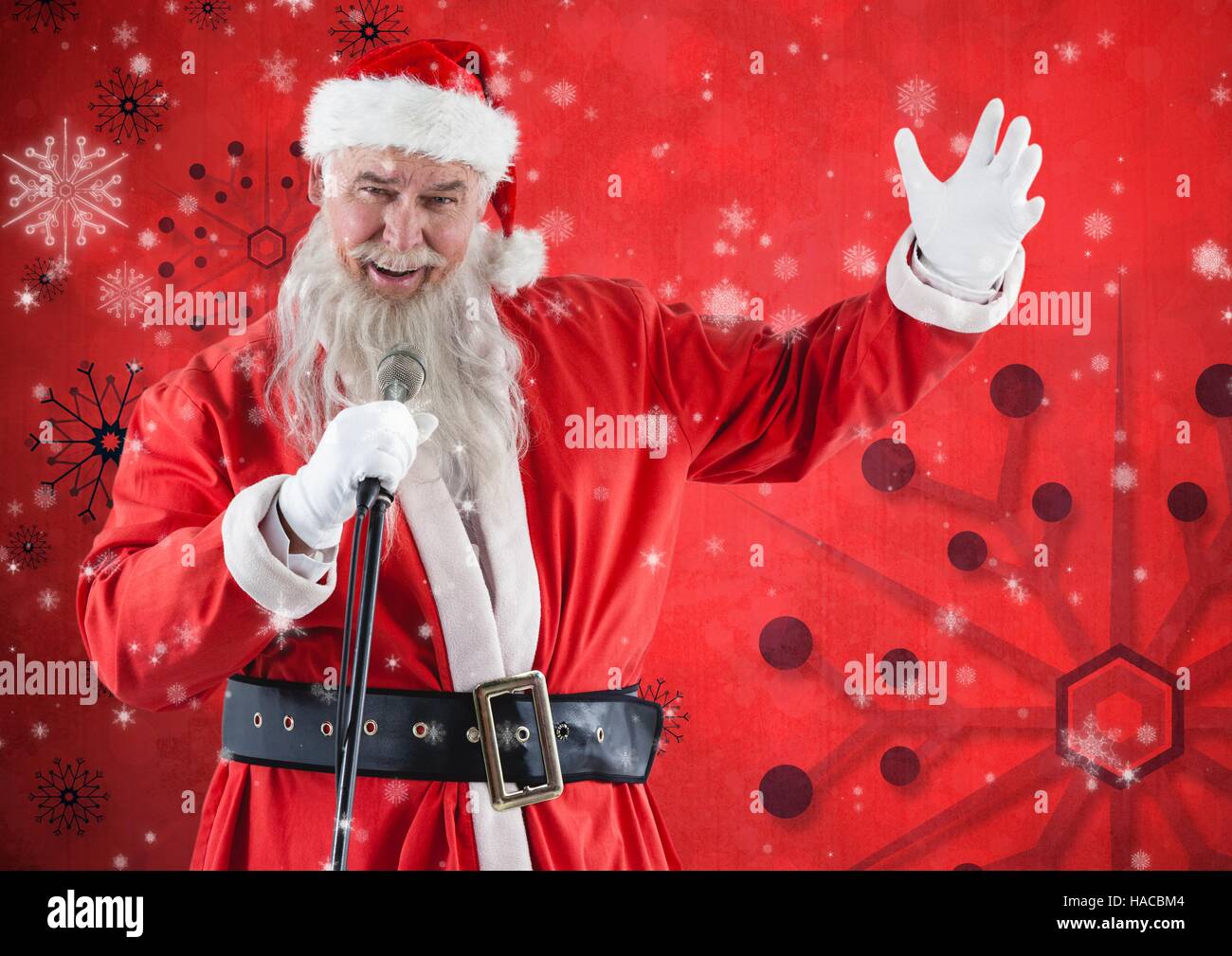 Santa claus with a microphone singing christmas songs Stock Photo - Alamy