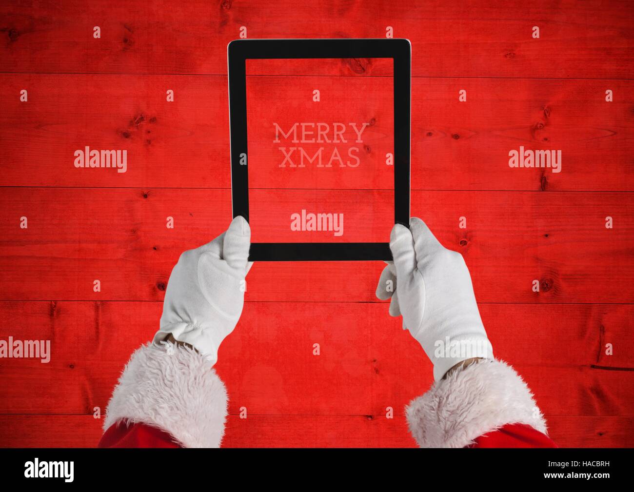 Hands of santa claus holding a digital tablet Stock Photo - Alamy