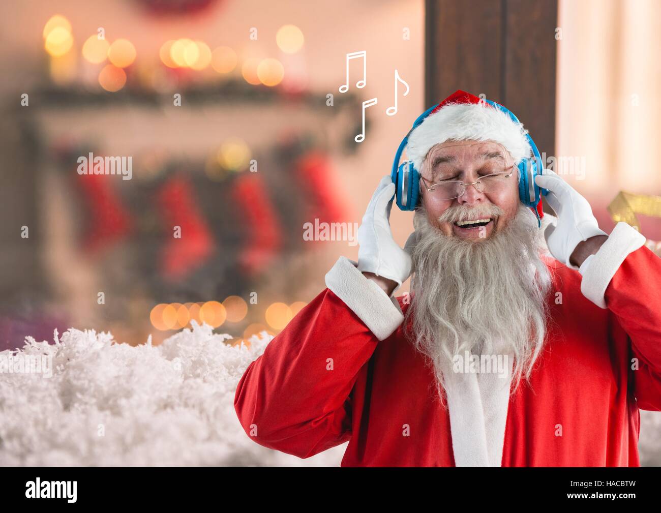 Cheerful Santa claus listening music Stock Photo - Alamy