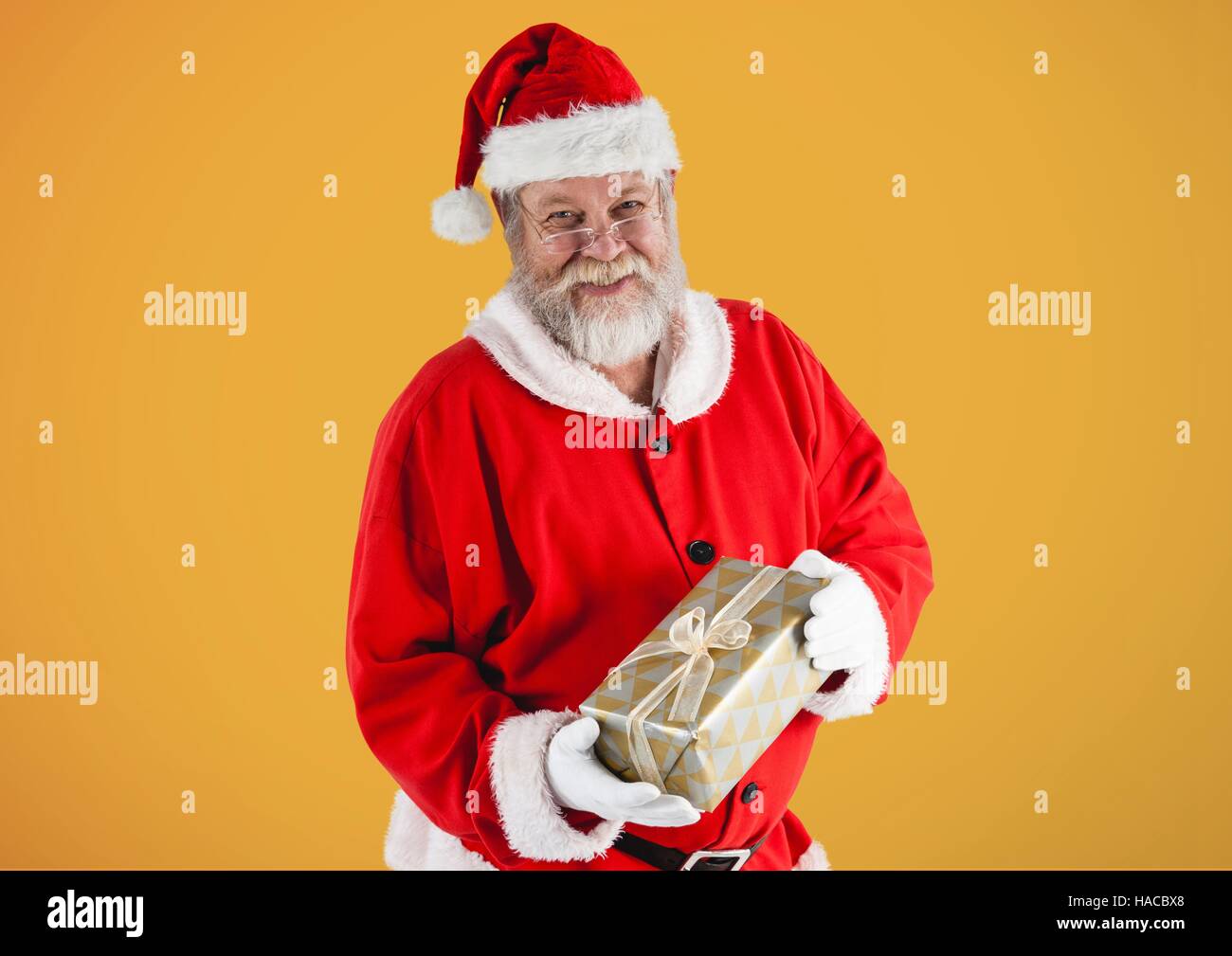 Santa claus holding gift box Stock Photo - Alamy