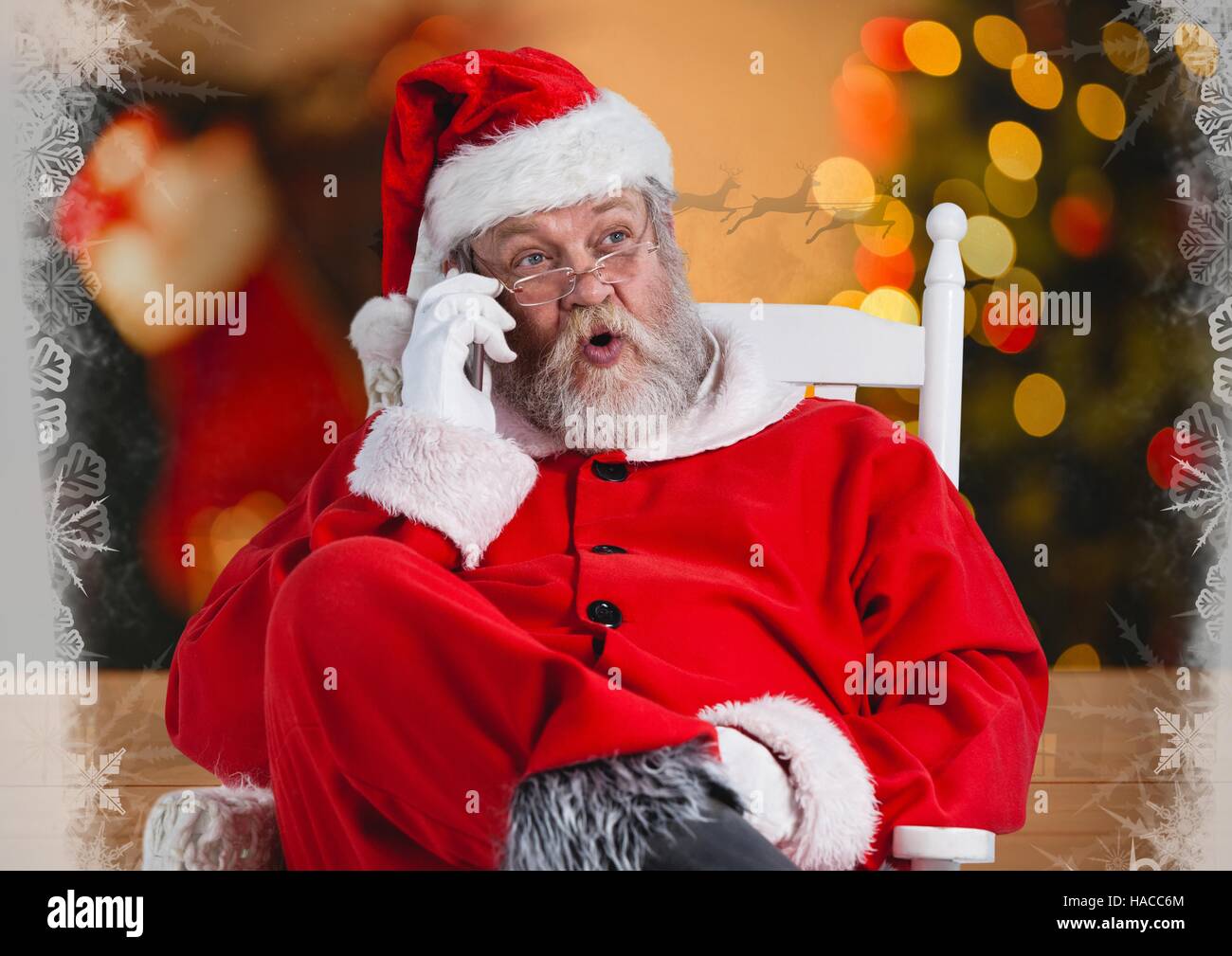 Santa talking on his phone while sitting on a chair Stock Photo - Alamy