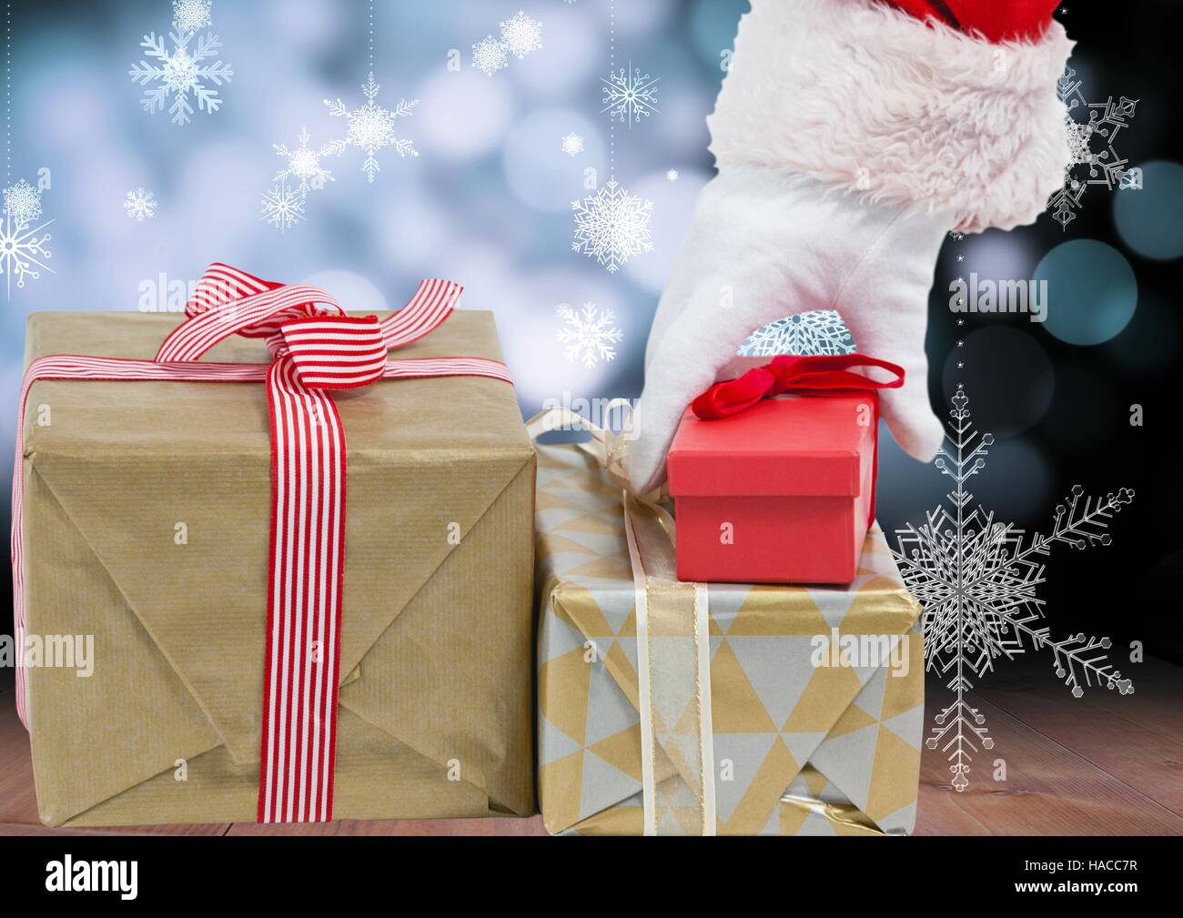 Hand of santa claus picking up christmas gifts Stock Photo - Alamy
