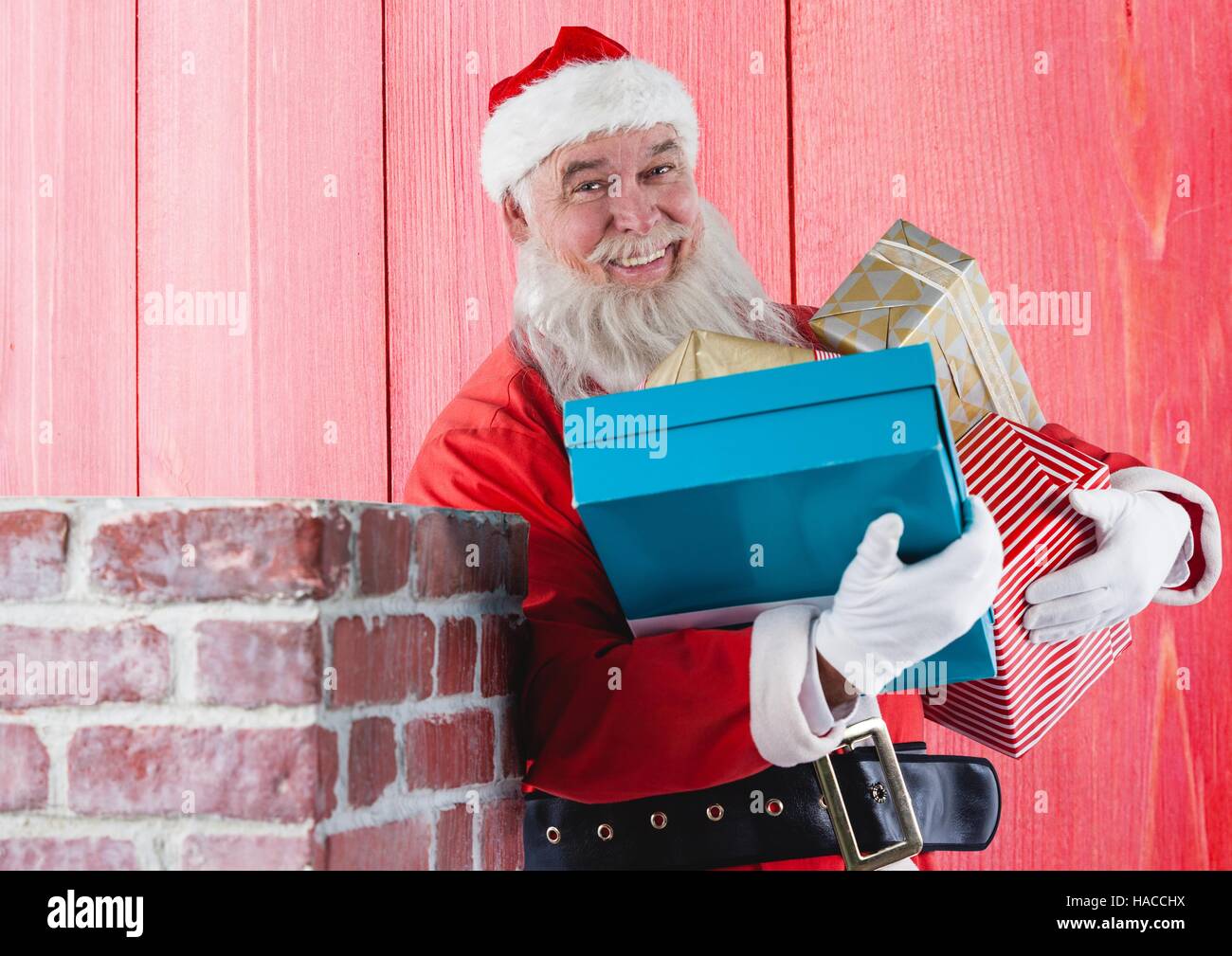 Smiling santa holding present hi-res stock photography and images - Alamy
