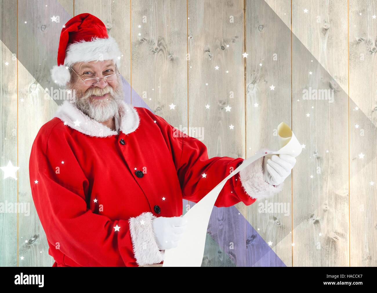 Happy santa holding checklist Stock Photo - Alamy