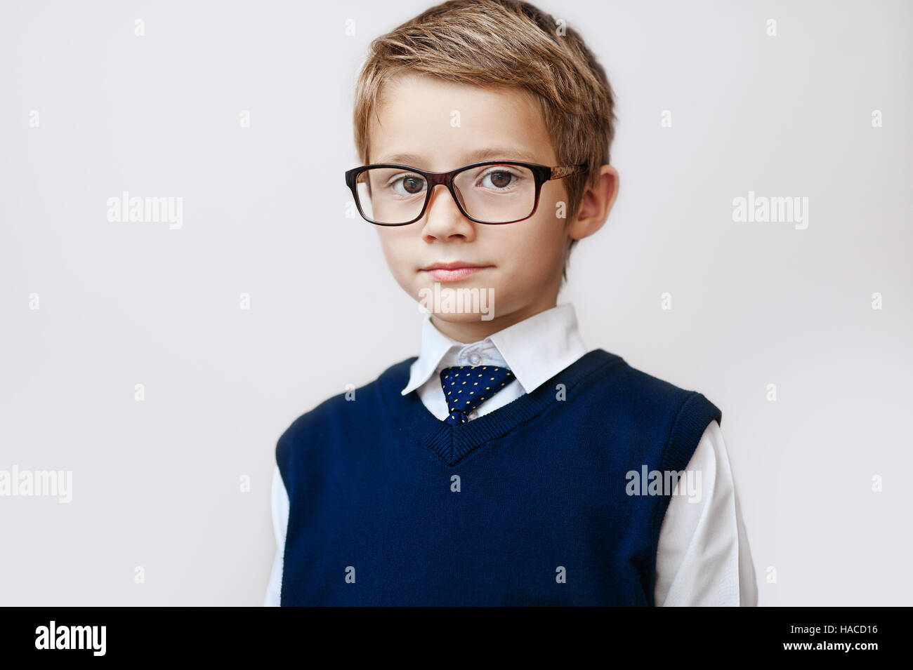 Portrait of a serious little boy in spectacles and vest Stock Photo - Alamy