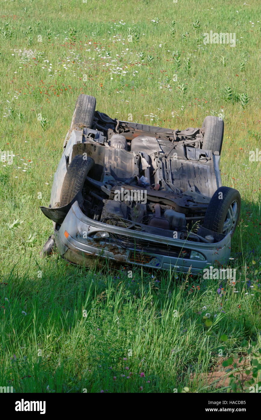 overturned car in field Stock Photo - Alamy