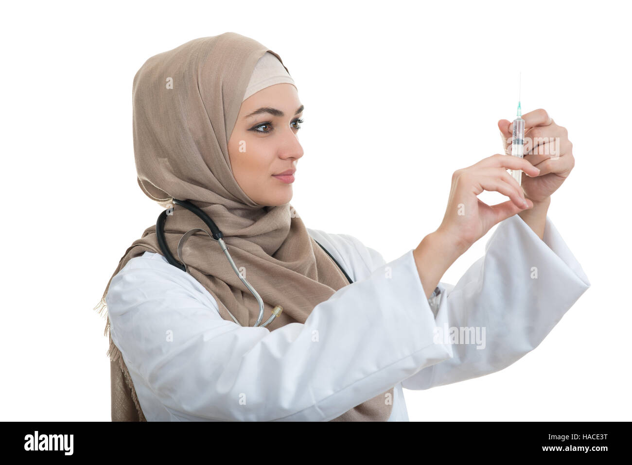 Muslim female medical doctor filling the syringe getting ready for a ...