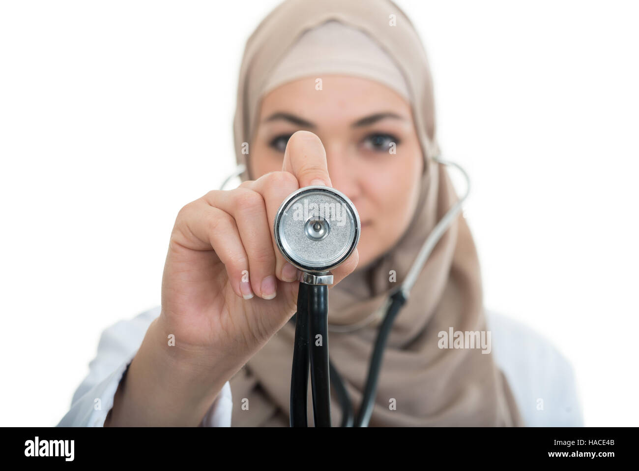close up portrait of arab female doctor smiling while using stethoscope ...
