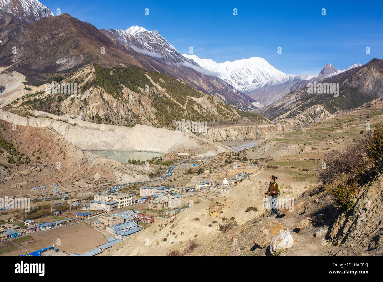 Young woman looking at the beautiful mountain landscape with a Manang ...