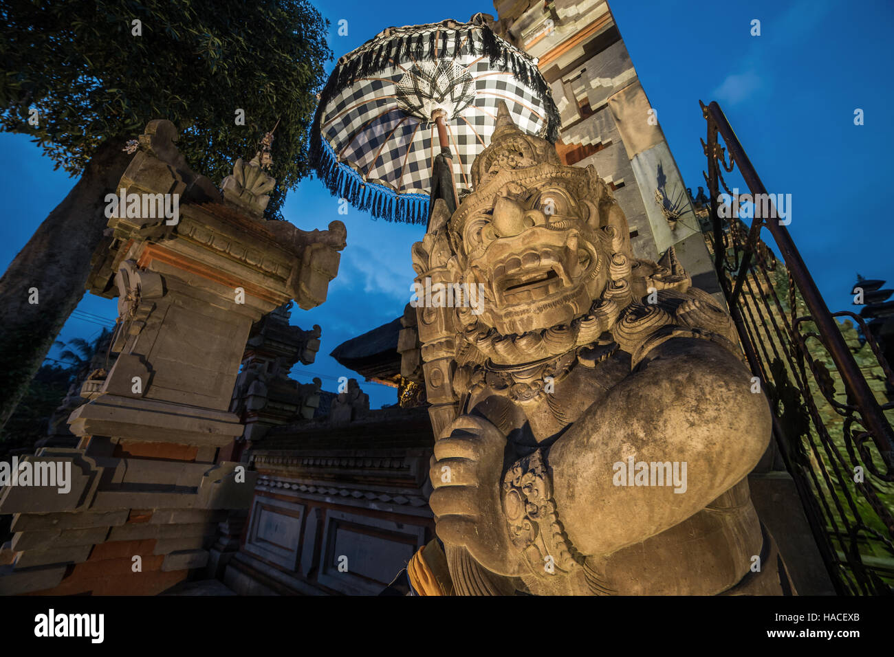 Traditional guard demon statue carved in dark stone on Bali island ...