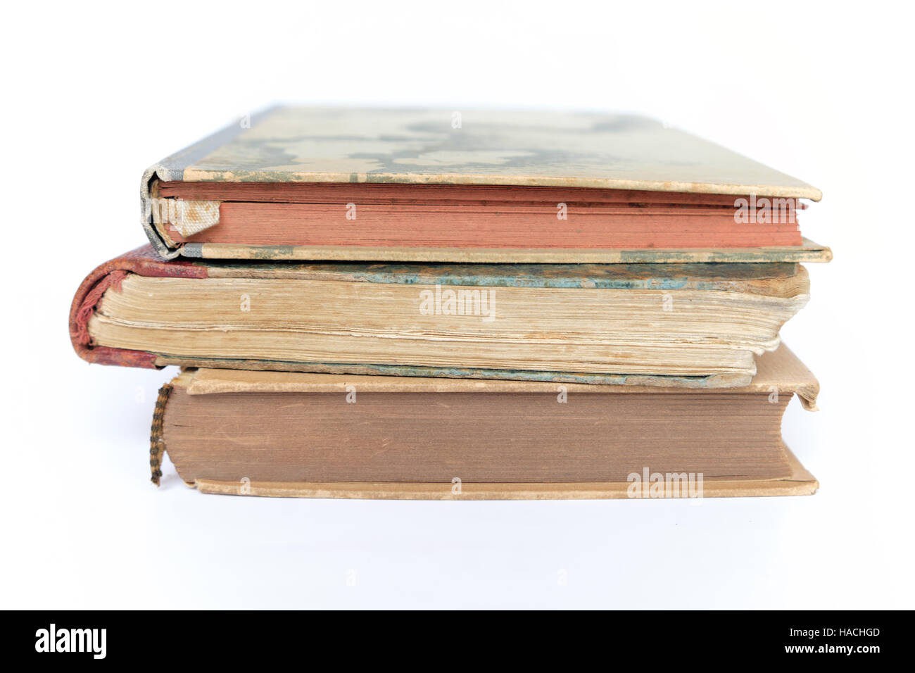 three old books stacked on white table Stock Photo - Alamy