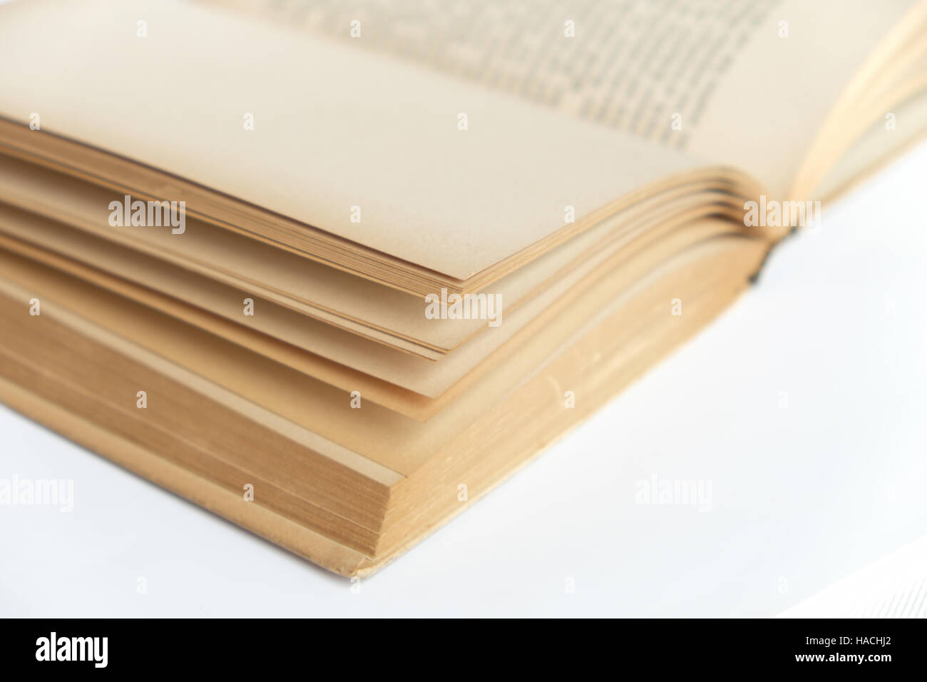 open old book closeup on white table Stock Photo - Alamy