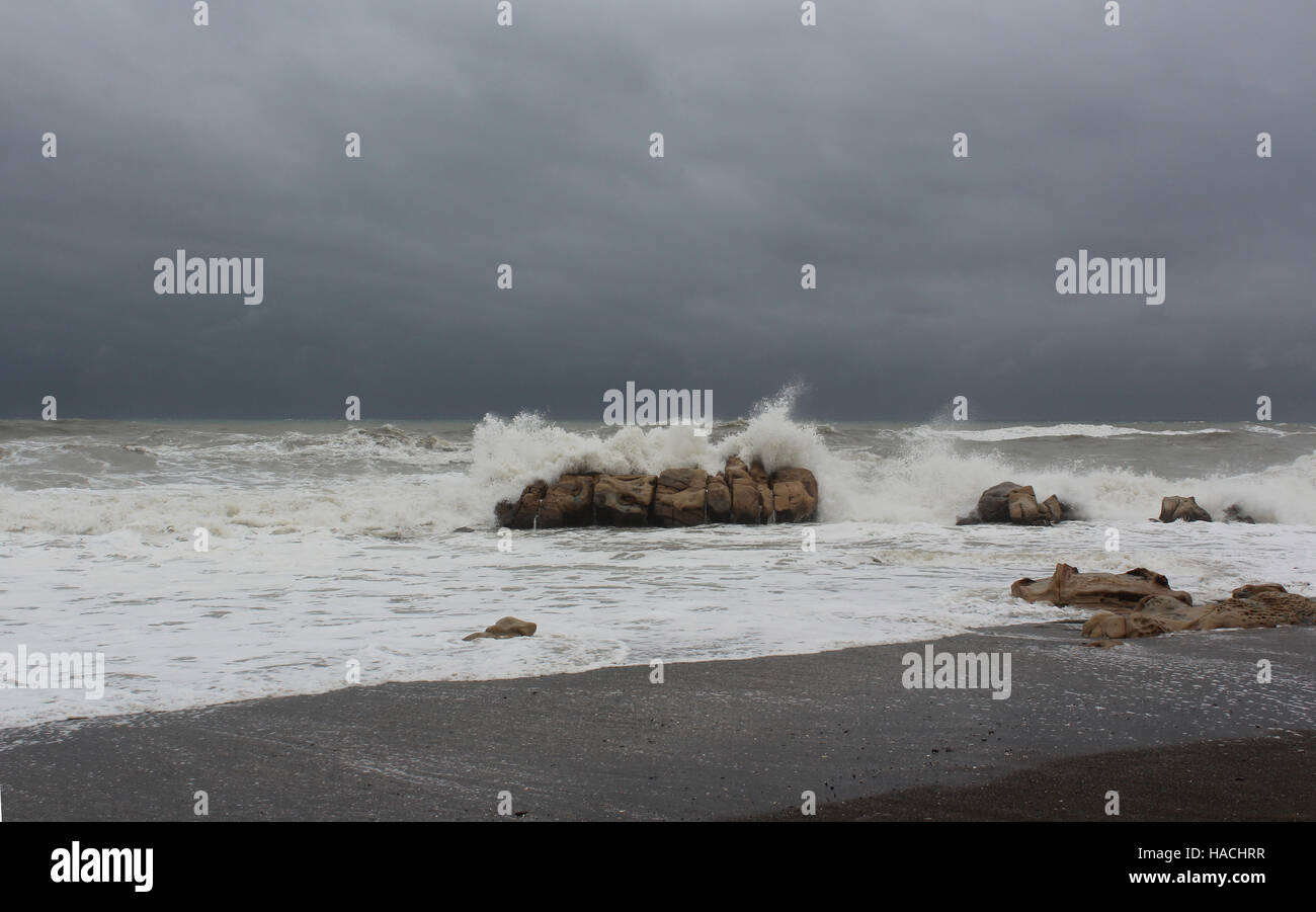 Wave crashing against rock on the beach hi-res stock photography and ...