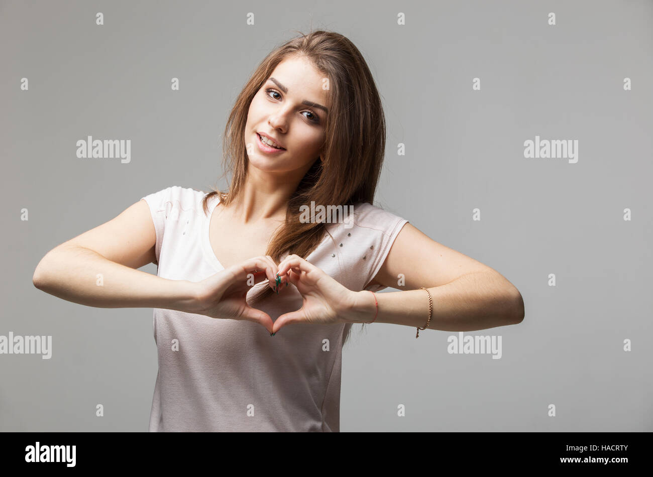 Beautiful woman making a heart symbol with her hands Stock Photo - Alamy
