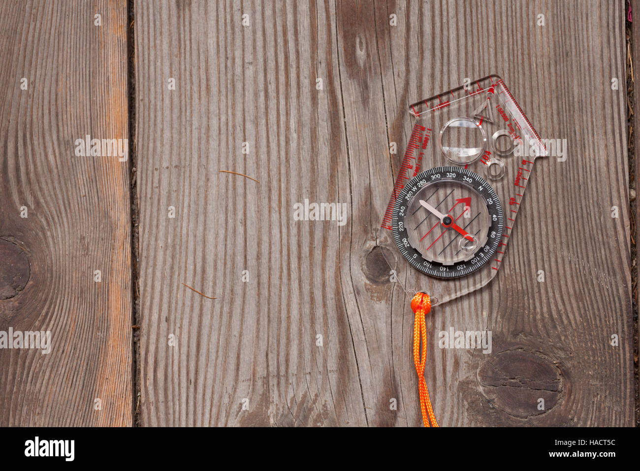 plastic compass over a wooden background Stock Photo - Alamy